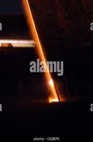 A firework rocket shoots into the night sky and explodes over Londons ...