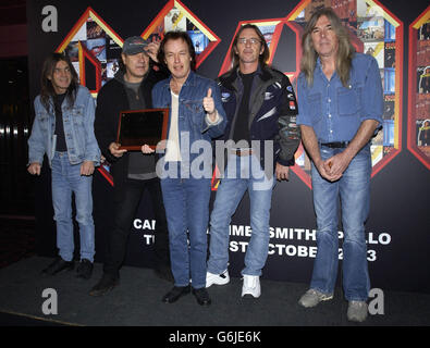 Angus Young from Rock group AC/DC poses for photographers at Carling ...