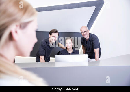 Doctors and receptionist at reception of dental surgery Stock Photo - Alamy