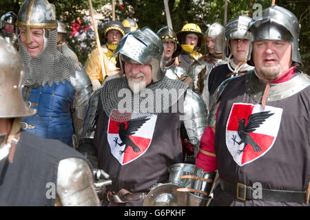 Knights in armor marching on the battlefield at the re-enactment of the ...