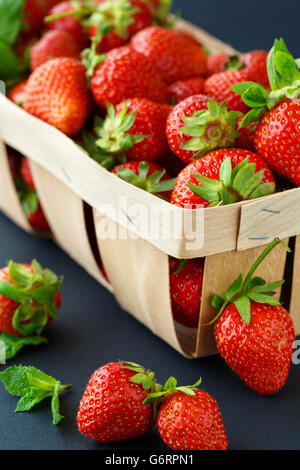 Strawberries in a bowl. Black background. Studio shooting Stock Photo ...