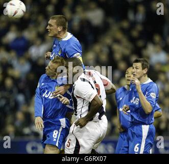 Jason Roberts of Wigan Athletic rises for a high ball watched by ...