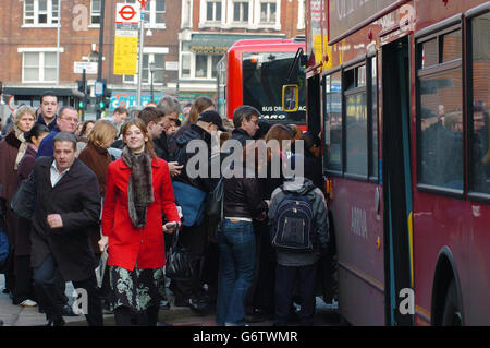 Londoners queue to take the bus during rush-hour on a busy Monday ...