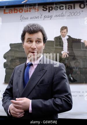 Shadow Chancellor Gordon Brown stands in front of Labour's latest ...