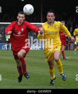 Jon Newby of York City (red) battles his way through the Cheltenham ...