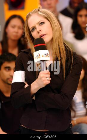Canadian singer Avril Lavigne wears a large ring on her engagement ...