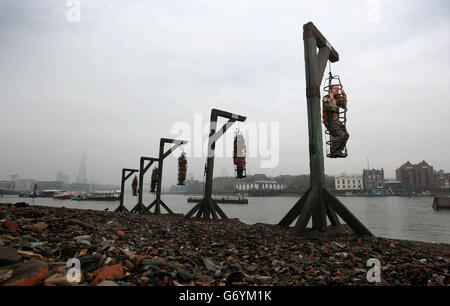 Actors dressed as pirates hang in gibbets at Execution Dock in Wapping ...