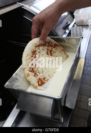 A battered and deep fried pizza, known locally as a pizza crunch, is ...