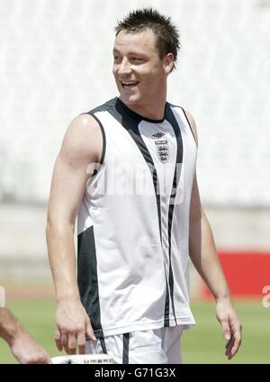 England defender John Terry walks off the pitch with coach Ray Clemence ...