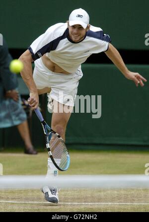 Roger Federer, from Switzerland, hits a forehand against Mardy Fish ...