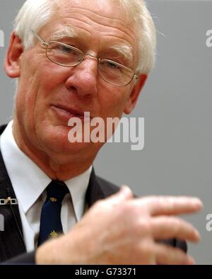 Lord Butler speaking at a news conference in London, following the ...
