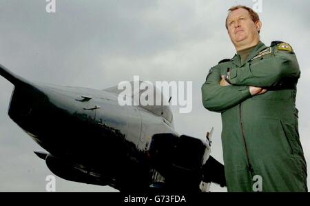 Station Commander Graham Wright stands alongsige a Jaguar fighter jet ...