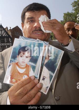 Daoud Mousa holds pictures of his grandchildren and son Baha outside ...