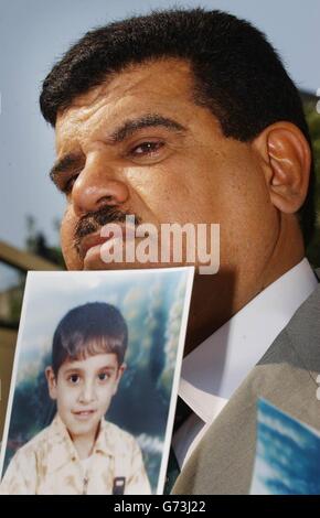 Daoud Mousa holds pictures of his grandchildren and son Baha outside ...
