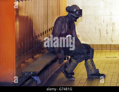 A dejected face worker sits in a Stillingfleet Colliery, York, locker ...