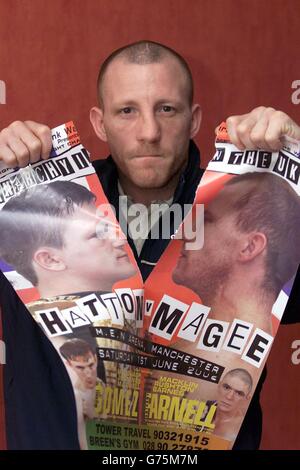 Belfast boxer Eamon Magee tears a poster carrying a photograph of his ...