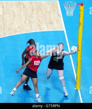 Wales Goalshooter Mair Jones (R) grabs a rebound over Canada's ...