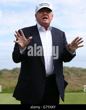 Donald Trump chats with the media on the 14th tee whilst on a tour of ...