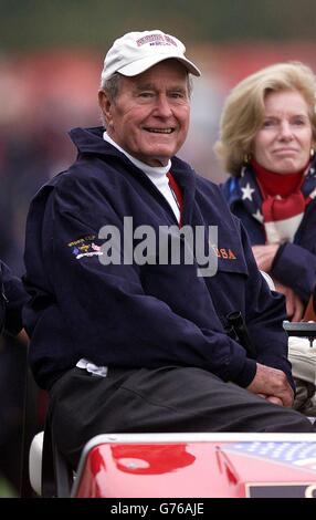 Former President George W. Bush, with cap raised, and Laura Bush ...