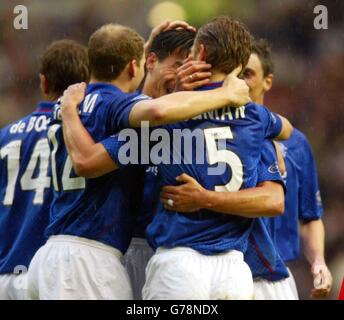 Rangers' Michael Mols celebrates with team mates Russell Lapety (l ...