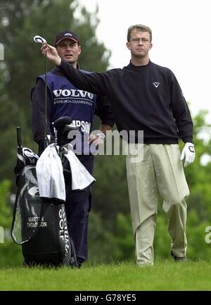 England's Martyn Thompson (right) prepares to play his second shot out ...