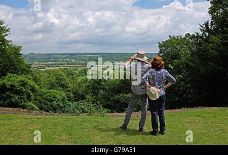 Stunning view some people admiring some hot air balloons flying over ...