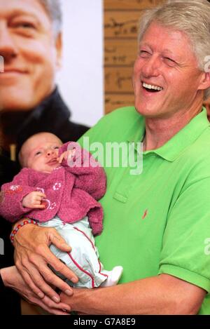 U.S President Bill Clinton holds up a New York Yankee baseball jersey ...
