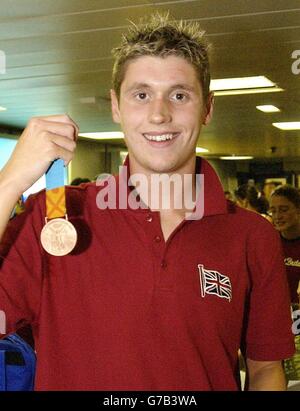 British Olympic swimmer David Davies shows off his bronze medal won in ...