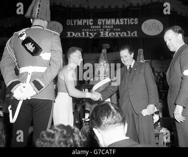 Jack Pancott receives his prize for winning the men's parallel bars ...