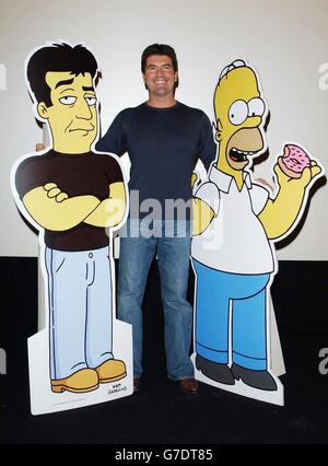 Simon Cowell poses with a cardboard cut-out of cartoon character Homer ...