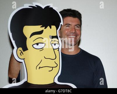 Simon Cowell poses with a cardboard cut-out of cartoon character Homer ...