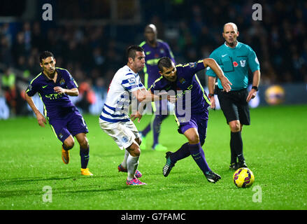Queens Park Rangers' Mauricio Isla (left) battles for the ball with ...