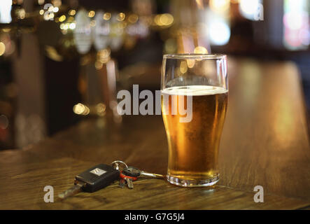 A pint of beer and a set of car keys on a bar in a pub in central ...