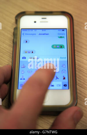 Emoji, also known as 'emoticons', being used on an iPhone 4s Stock ...