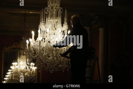 Conservator Robin Matthews removes the dust from a chandelier at ...