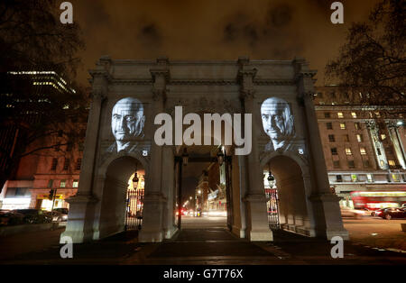 A portrait of Micky Eales, a London cabbie, is projected onto Waterloo ...