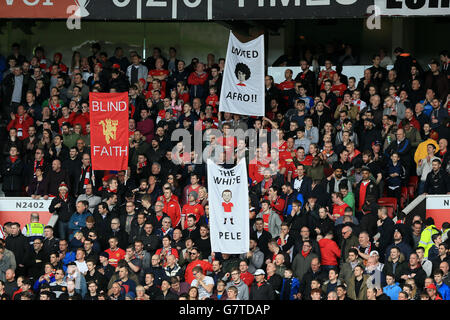 United fans hold up banners in the Stretford End during the Premier ...