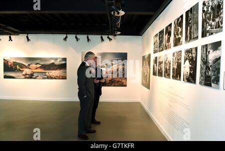 The Prince of Wales speaks with photographer Ian Lawson (right) as he ...