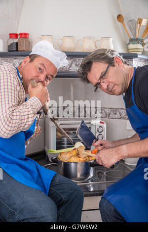 Too many cooks spoil the broth, a conceptual shot with two useless male ...