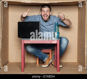 Happy unemployed young man with box of personal office belongings on ...