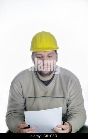Young construction engineer with yellow helmet crane and construction ...