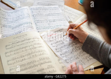 Composer editing musical score Stock Photo - Alamy