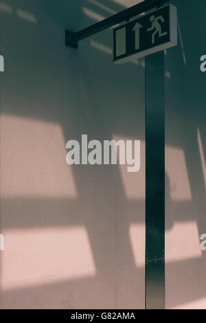 Exit sign on the wall in a building Stock Photo - Alamy