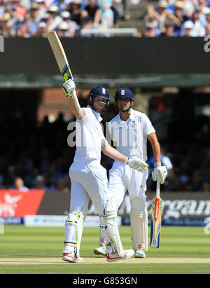 England's Alastair Cook raises his bat after scoring 50 not out during ...