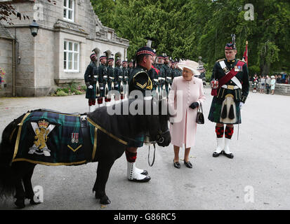 Queen Elizabeth II talks to Pony Major Mark Wilkinson with regimental ...