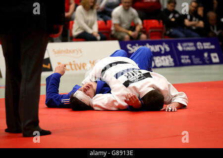Northern Ireland's James Reid (white) competes against Scotland's ...