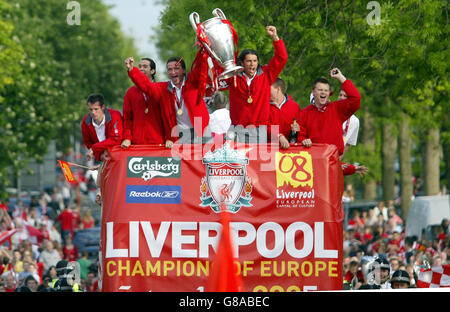 Liverpool players celebrate with the trophy on top of a bus during the ...