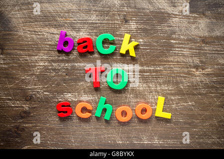 Sentence Back to school in colorful plastic letters and blank notebook ...