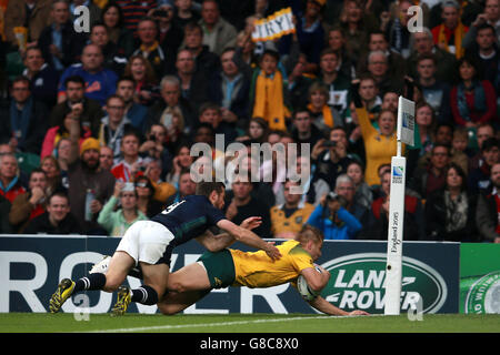 Australia's Drew Mitchell scores a try despite the challenge of ...