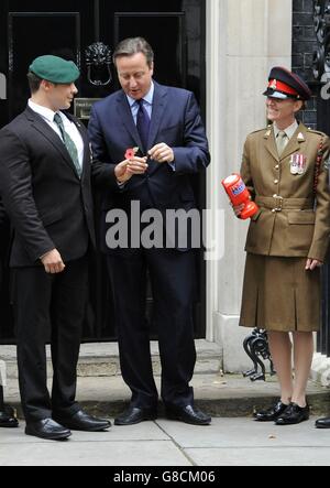 The Prime Minister buys his poppy during his early morning walk on ...